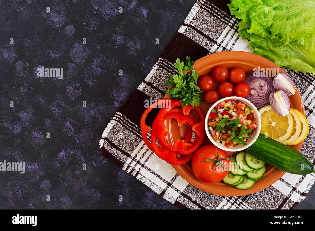 Salsa with ingredients on dark background. Top view Stock Photo - Alamy