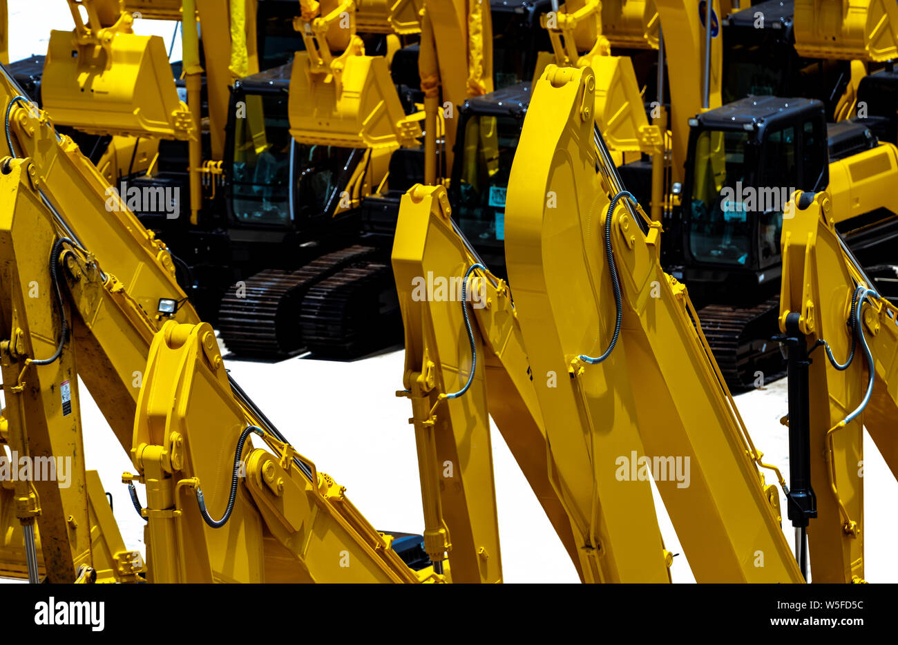 Yellow backhoe with hydraulic piston arm isolated on white. Heavy ...