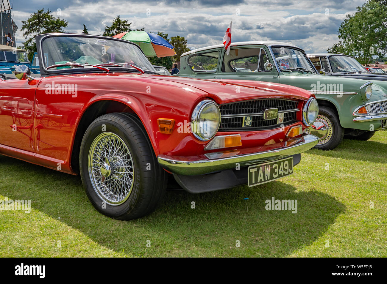 Front view of a vintage Triumph TR6 sports car, in brilliant red, on ...