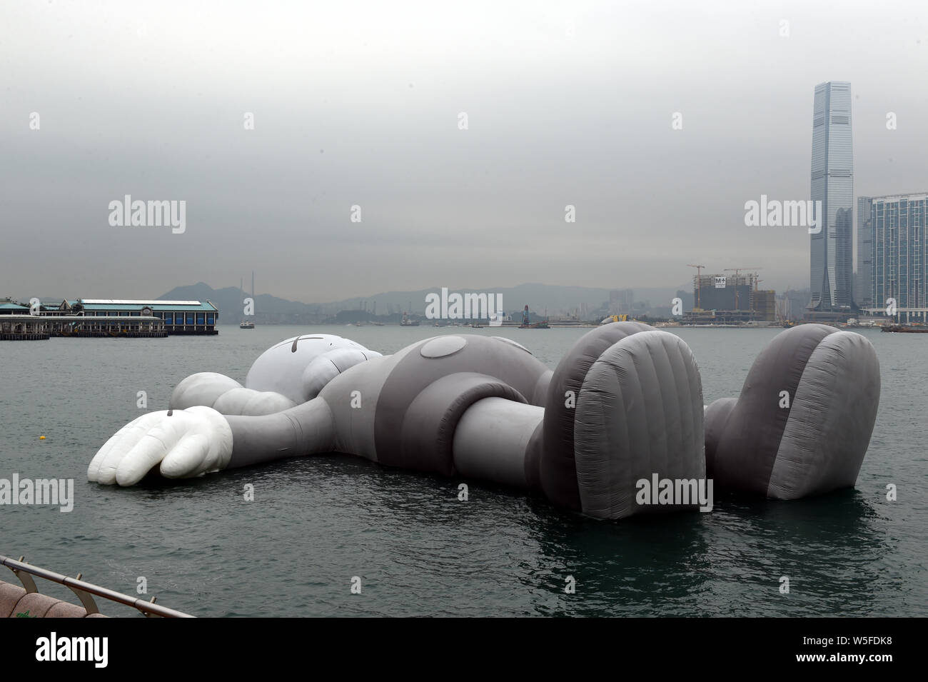 Visitors view the 37-metre-long floating sculpture by US artist Kaws at ...