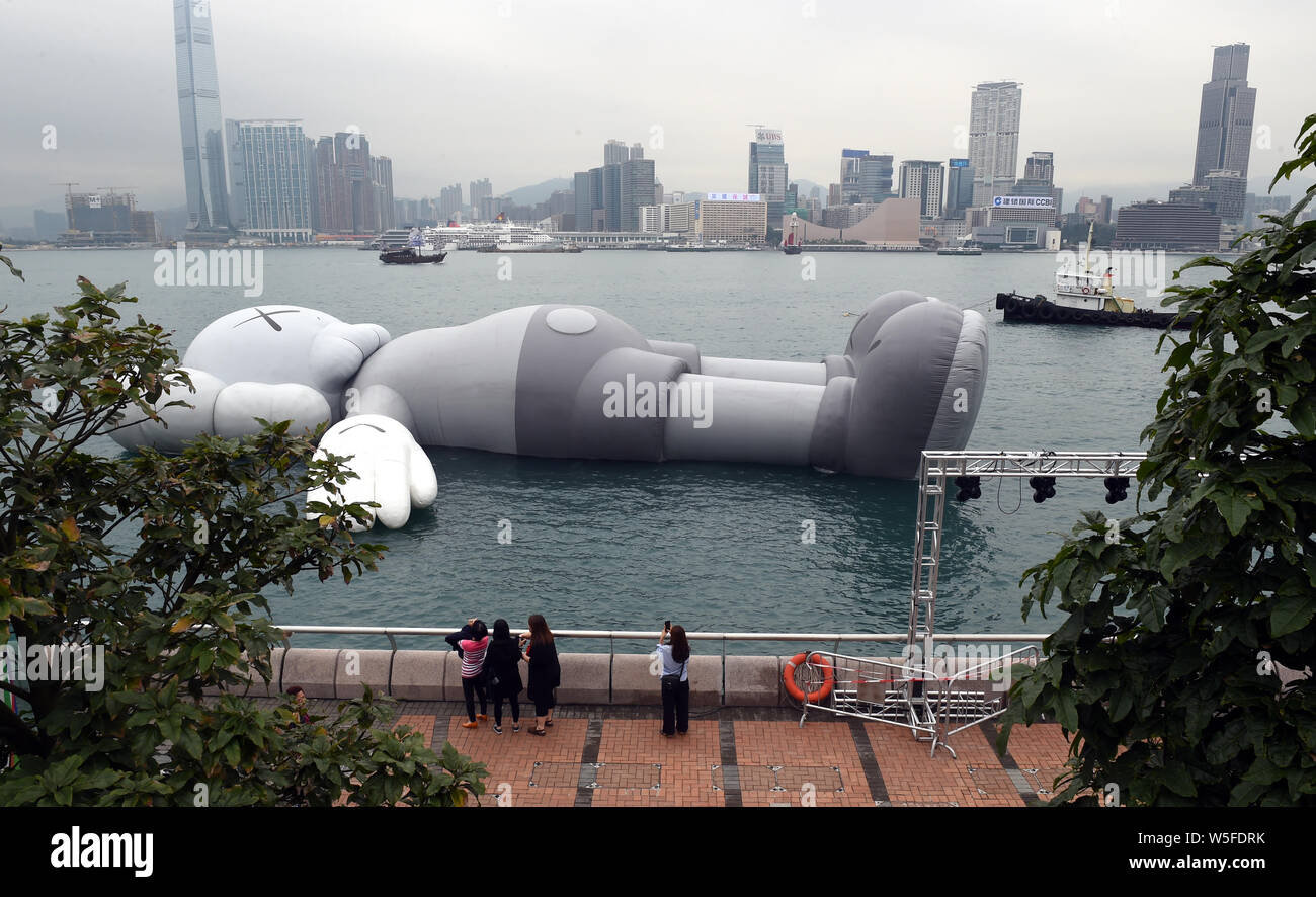 Visitors view the 37-metre-long floating sculpture by US artist Kaws at ...