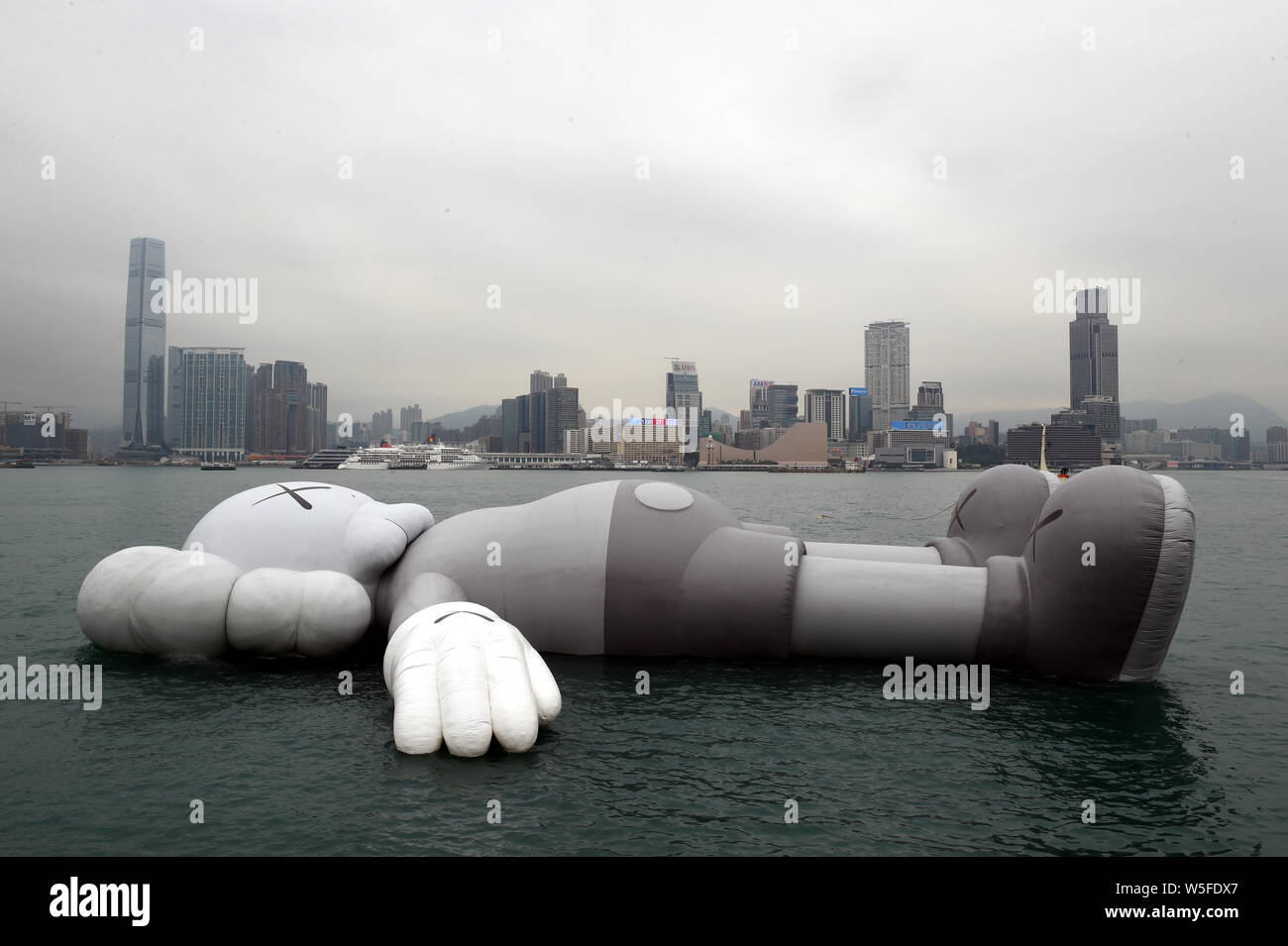 Visitors view the 37-metre-long floating sculpture by US artist Kaws at ...