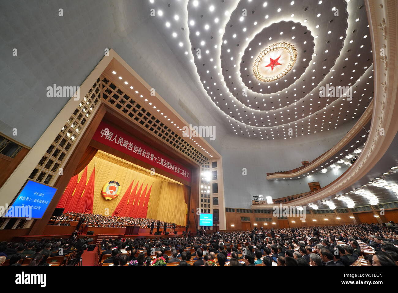 Delegates attend the opening meeting for the second session of the 13th ...