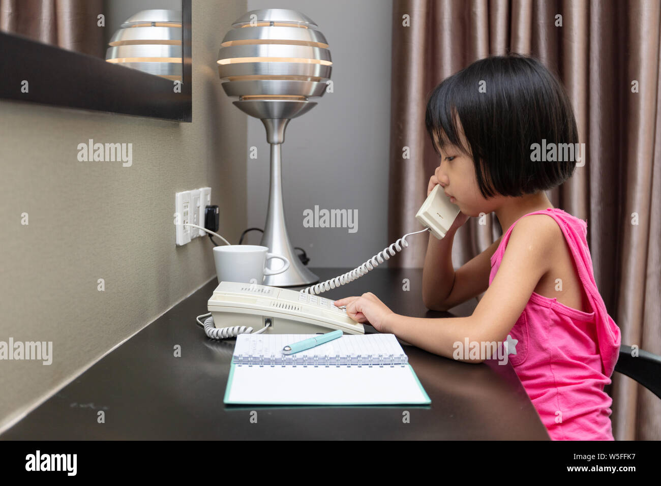 Asian Little Chinese Girl making calls at home Stock Photo - Alamy