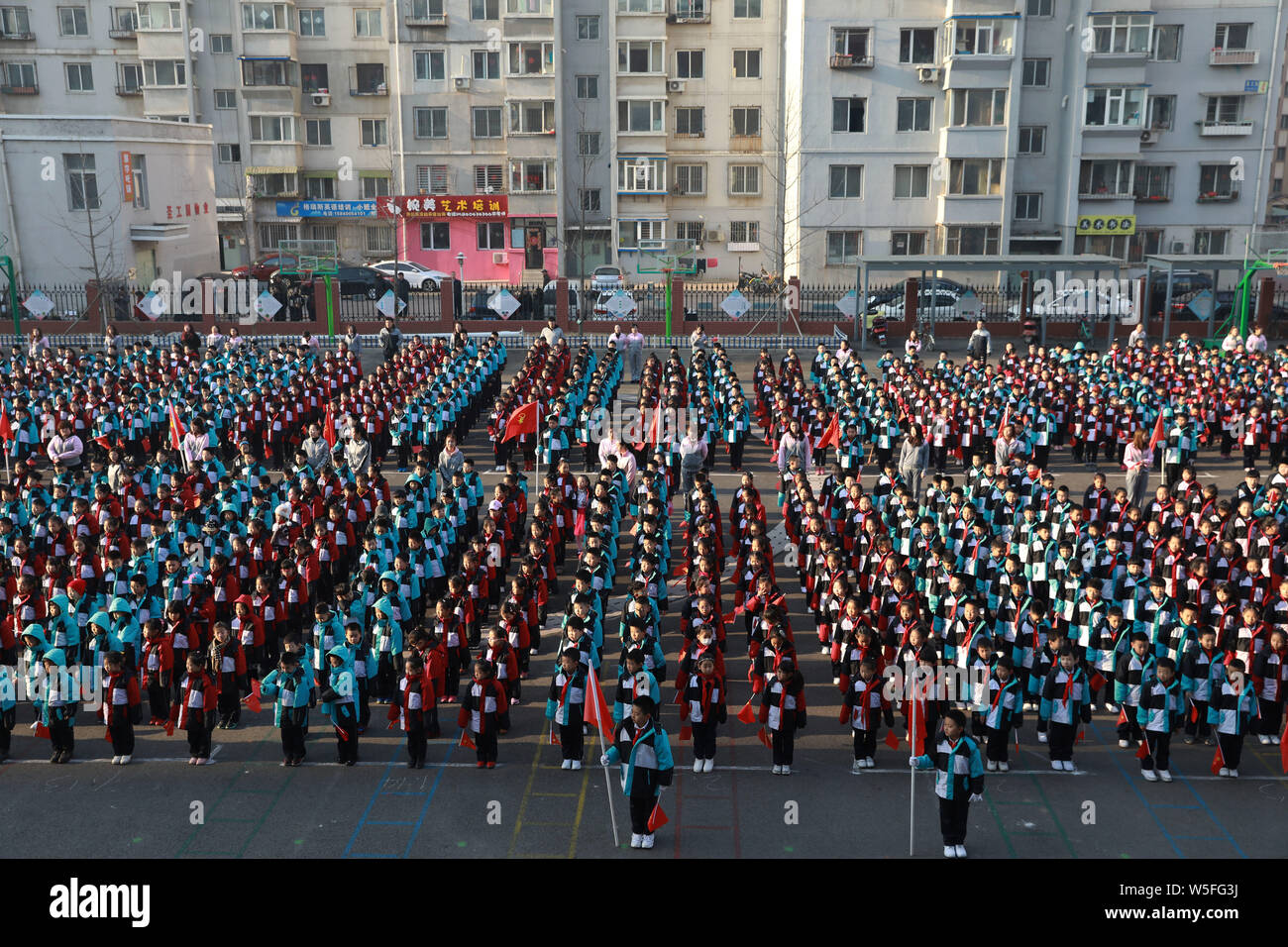 Young Chinese students wave Chinese national flags during the flag ...