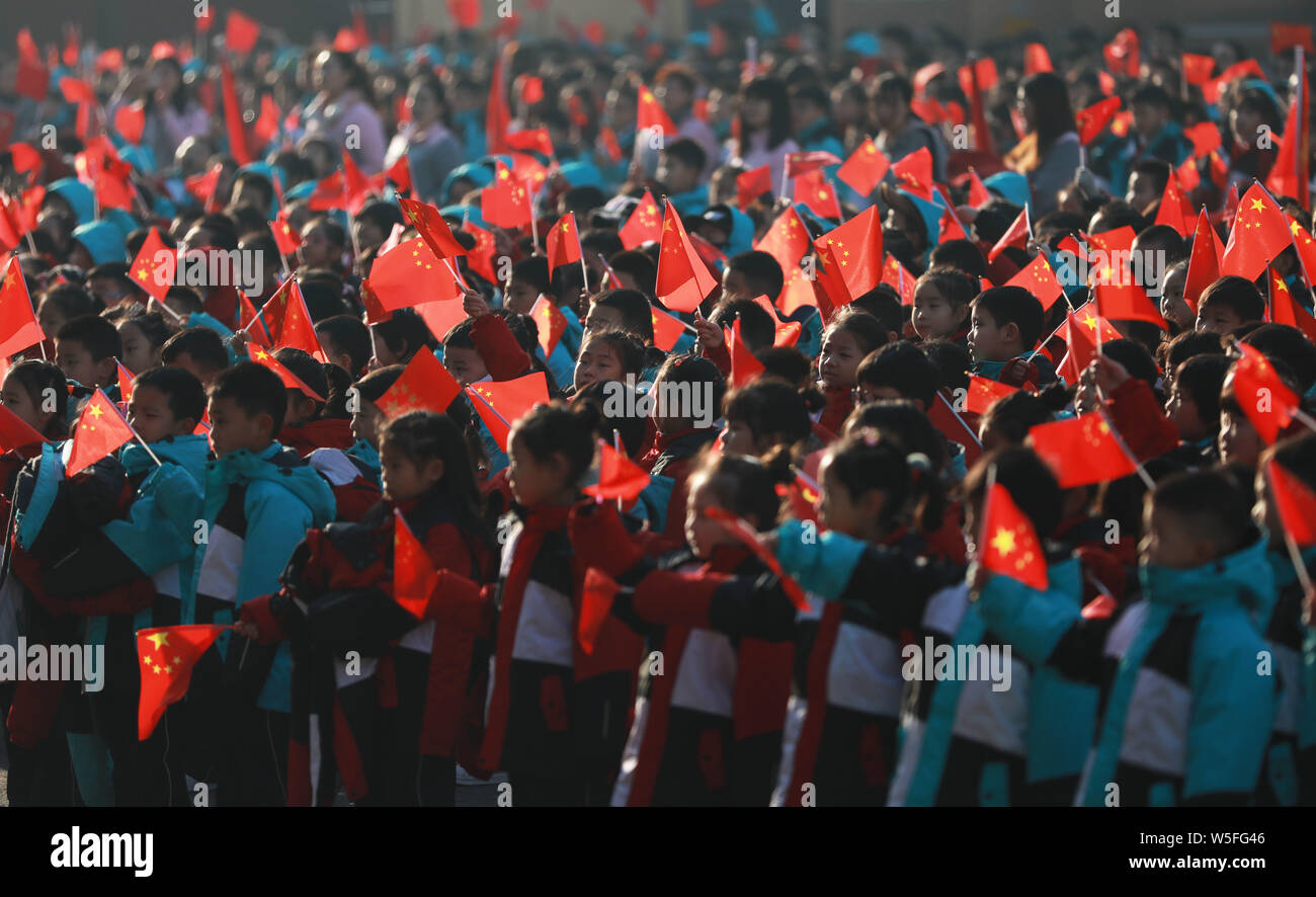 Young Chinese students wave Chinese national flags during the flag ...