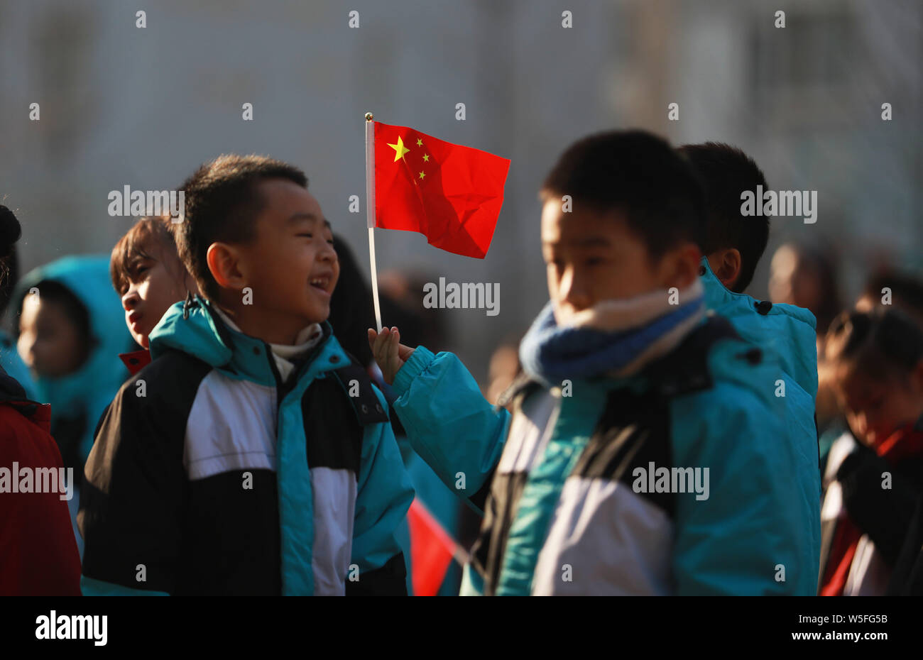 Young Chinese students wave Chinese national flags during the flag ...