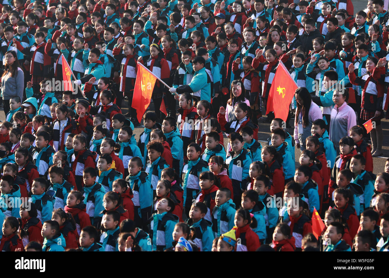 Young Chinese students wave Chinese national flags during the flag ...
