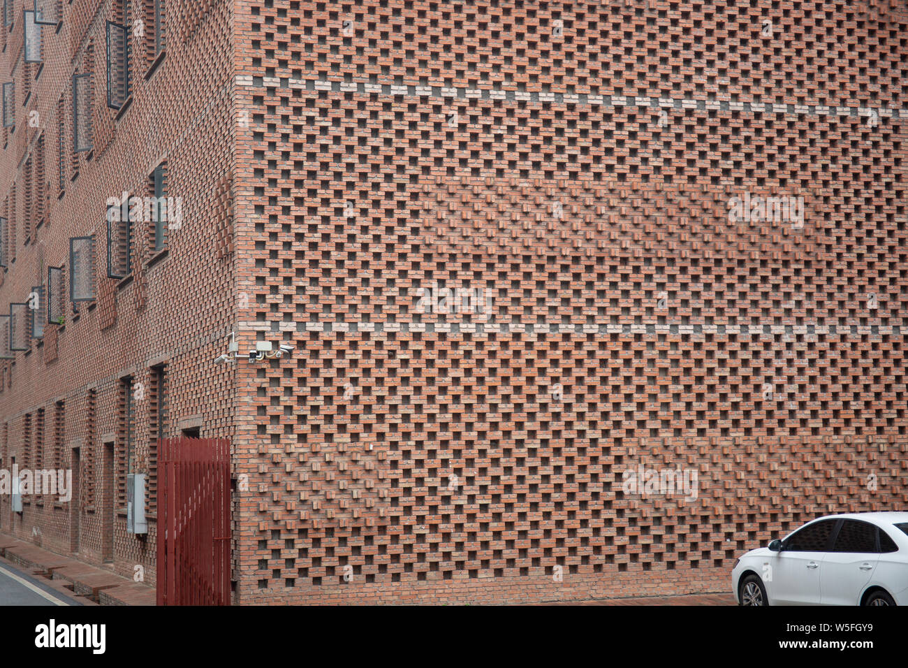 The holes are strewn on the surface of a building at the campus of a ...