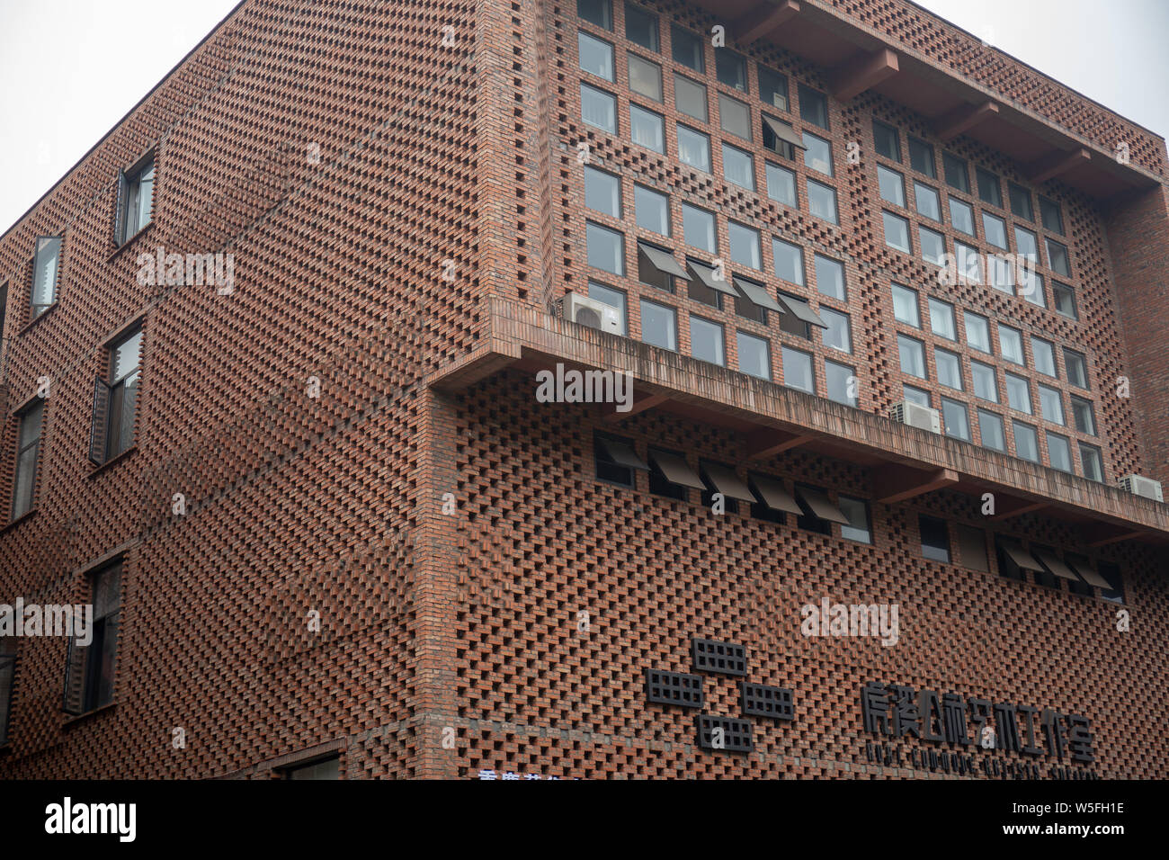 The holes are strewn on the surface of a building at the campus of a ...
