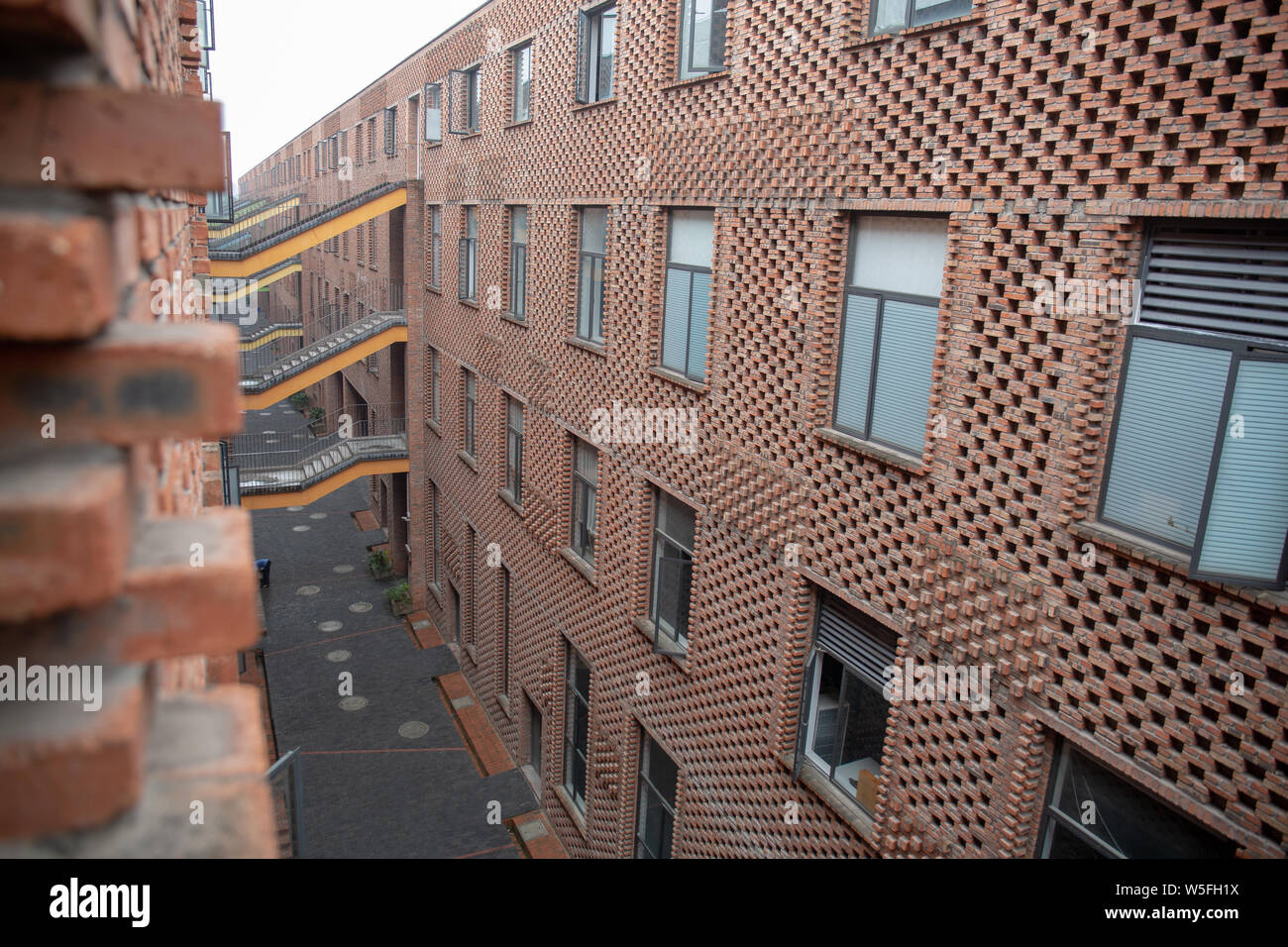 The holes are strewn on the surface of a building at the campus of a ...