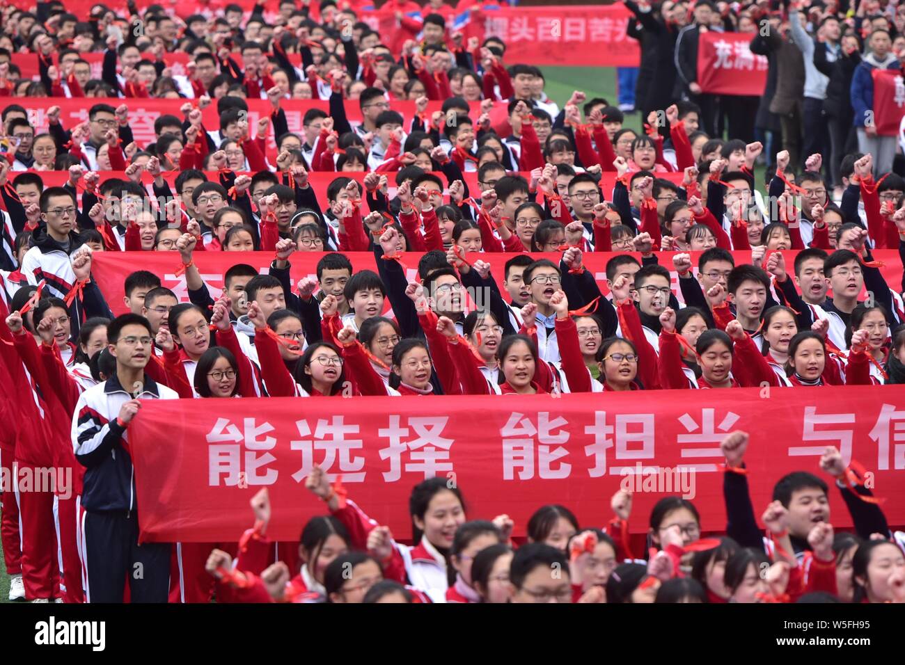 Chinese students queue up in lines during a mass rally for the upcoming ...