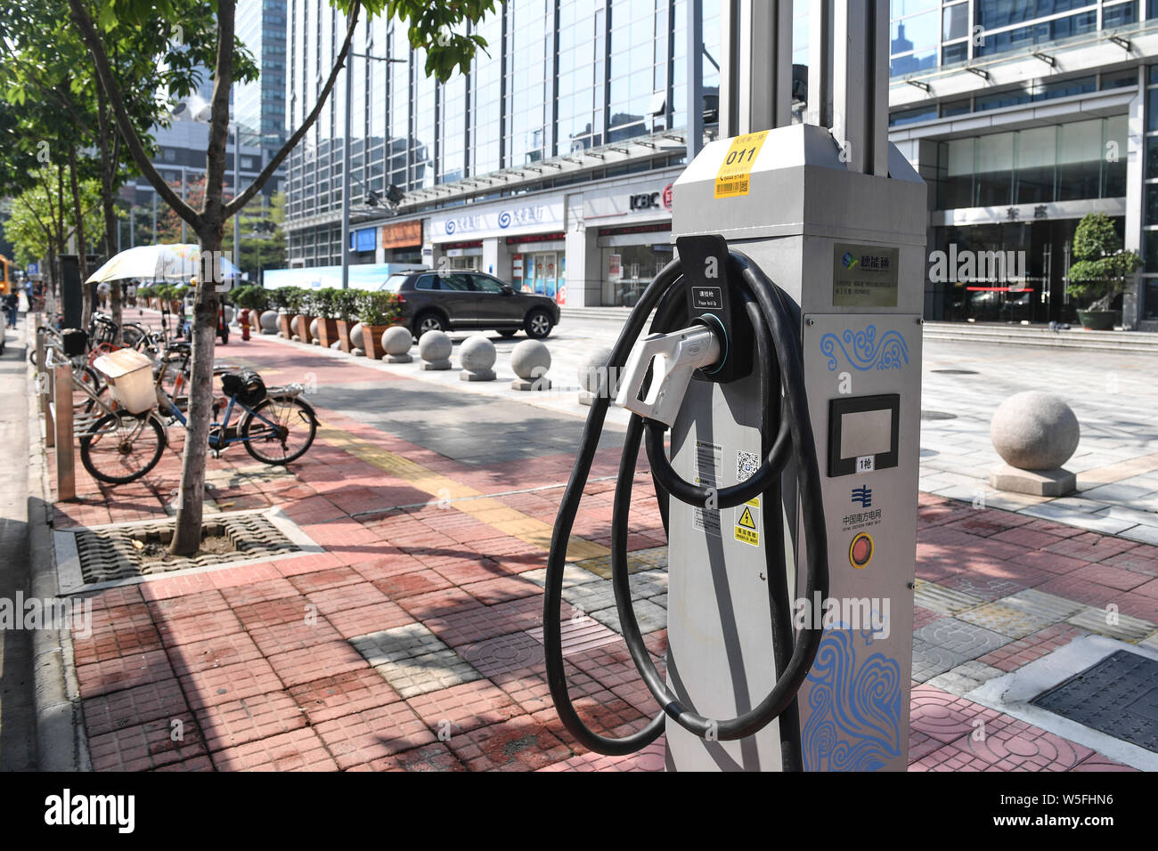 Cars drive past a smart street lamp used to promote the construction of ...