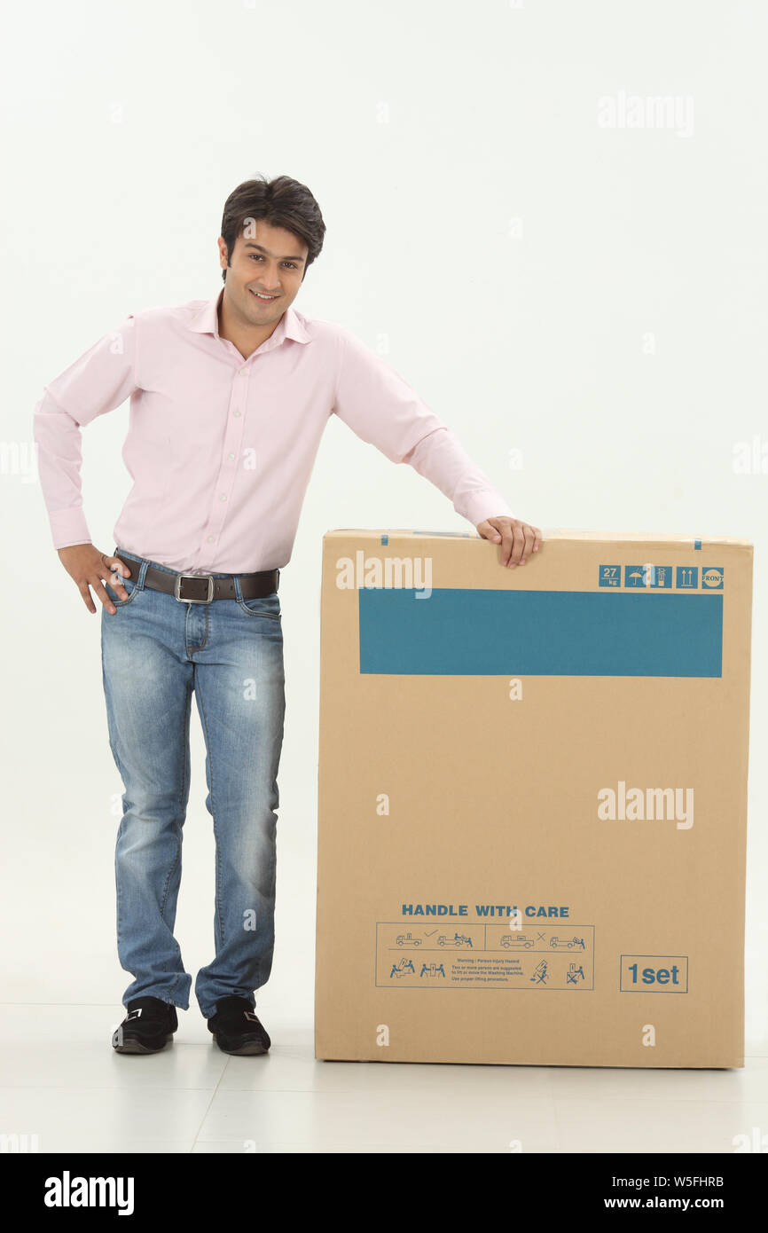 Salesman with a cardboard box and smiling Stock Photo - Alamy