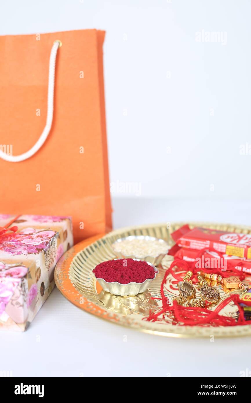 Indian festival: Raksha Bandhan background with an elegant Rakhi, Rice ...