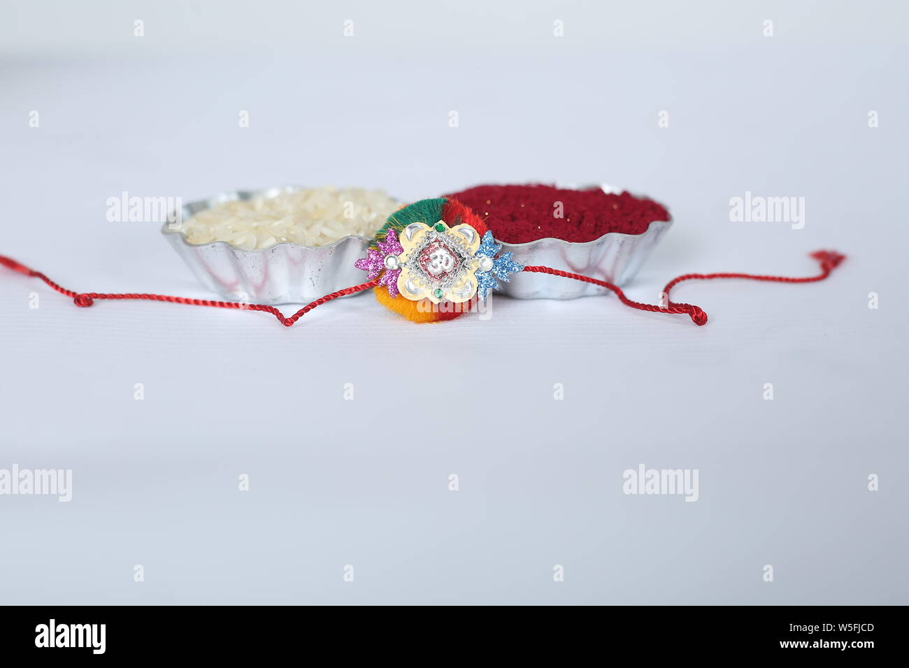 Indian festival: Raksha Bandhan background with an elegant Rakhi, Rice ...
