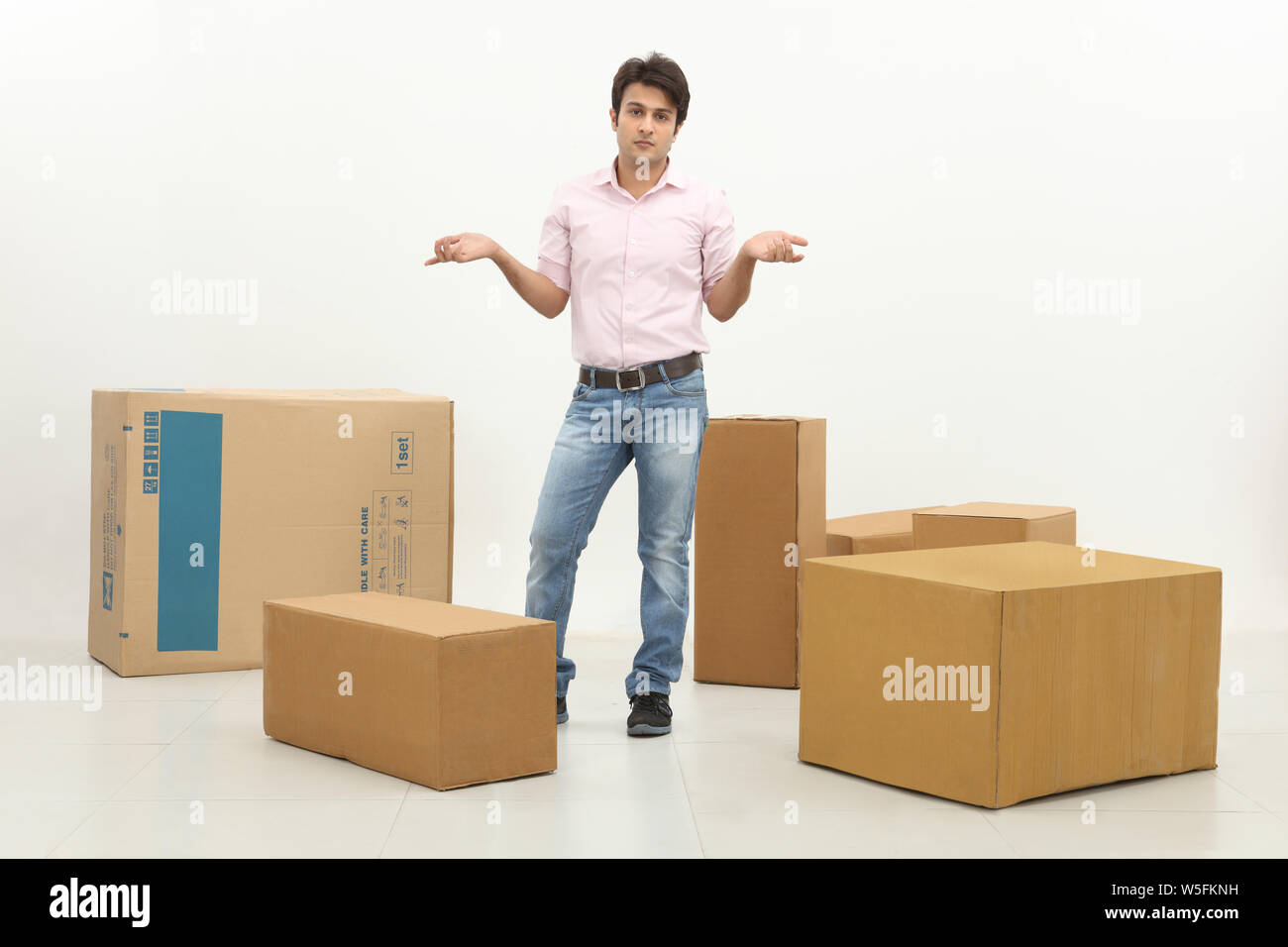 Man standing with cardboard boxes Stock Photo - Alamy