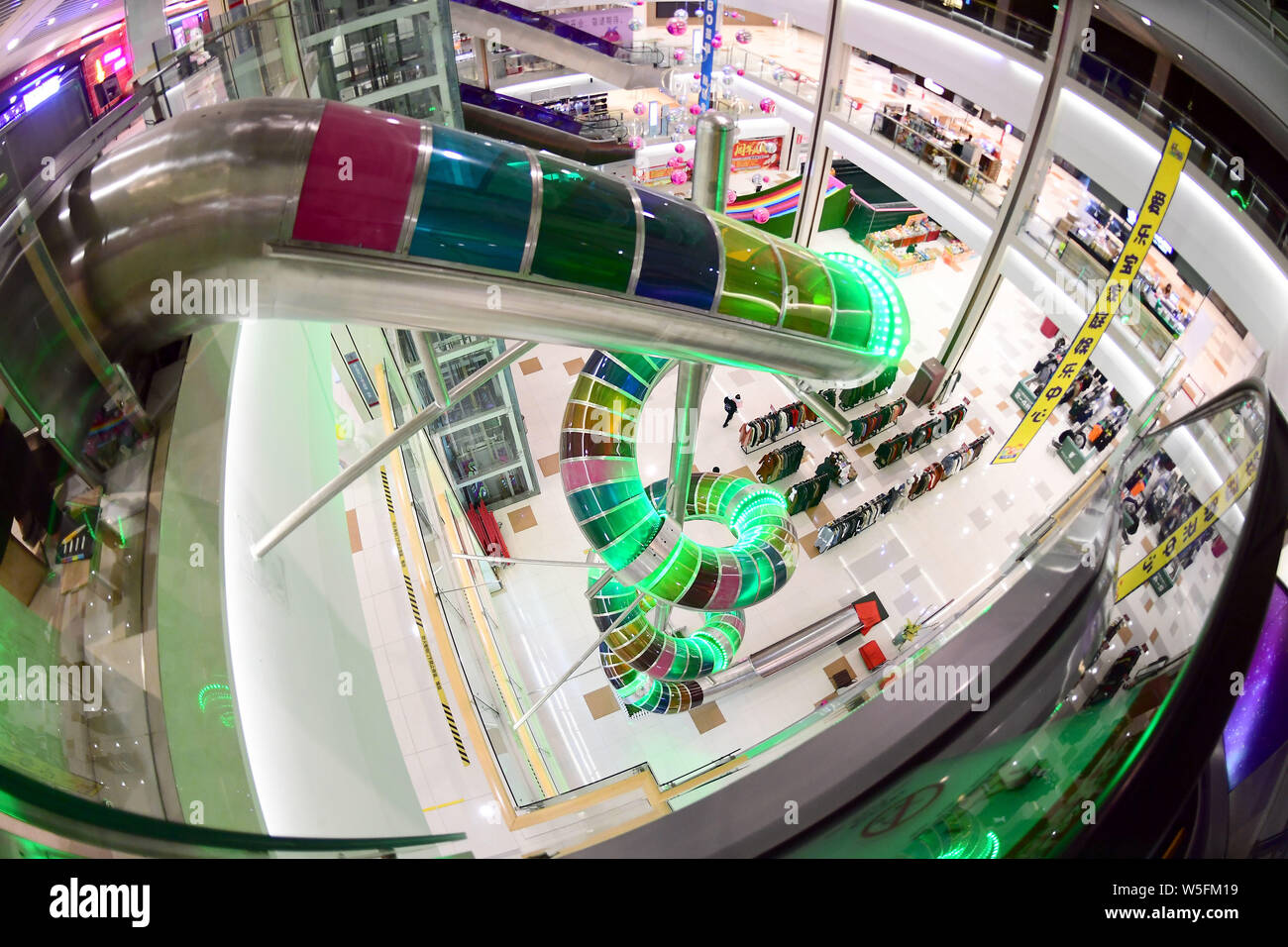 A customer tries out the 20-meter tall super slide at a shopping mall ...