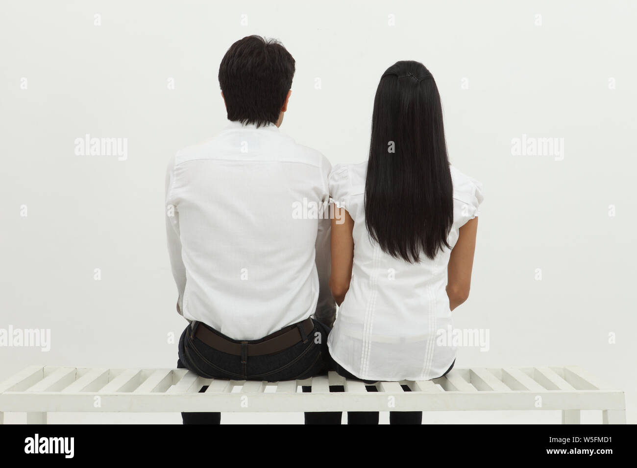 Rear view of a couple sitting on a bench Stock Photo - Alamy