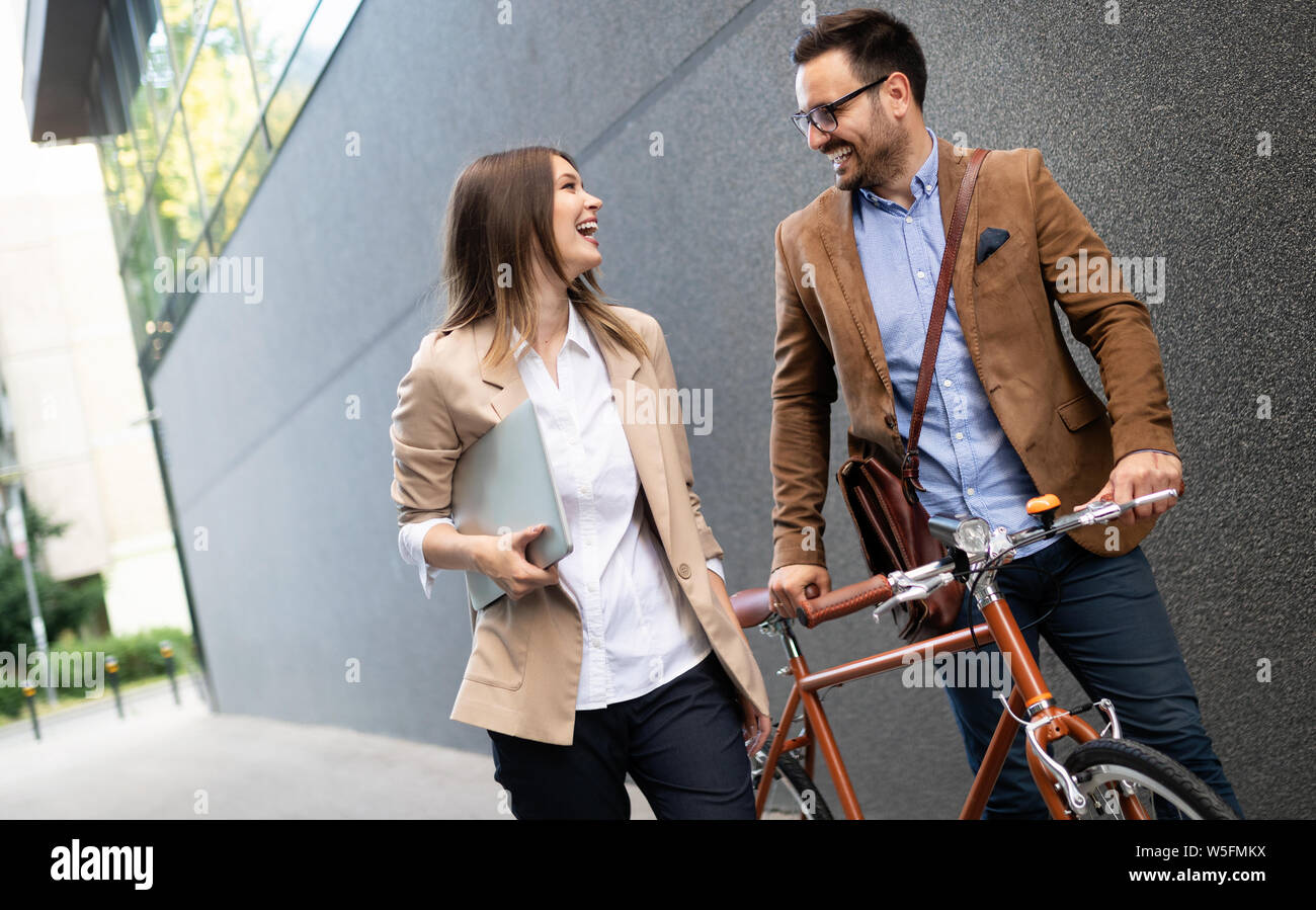 Happy business colleagues talking and walking in the city outdoor Stock ...