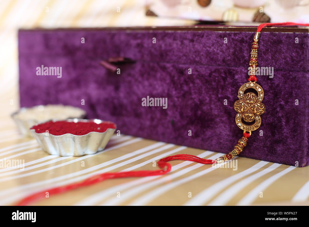 Indian festival: Raksha Bandhan background with an elegant Rakhi, Rice ...