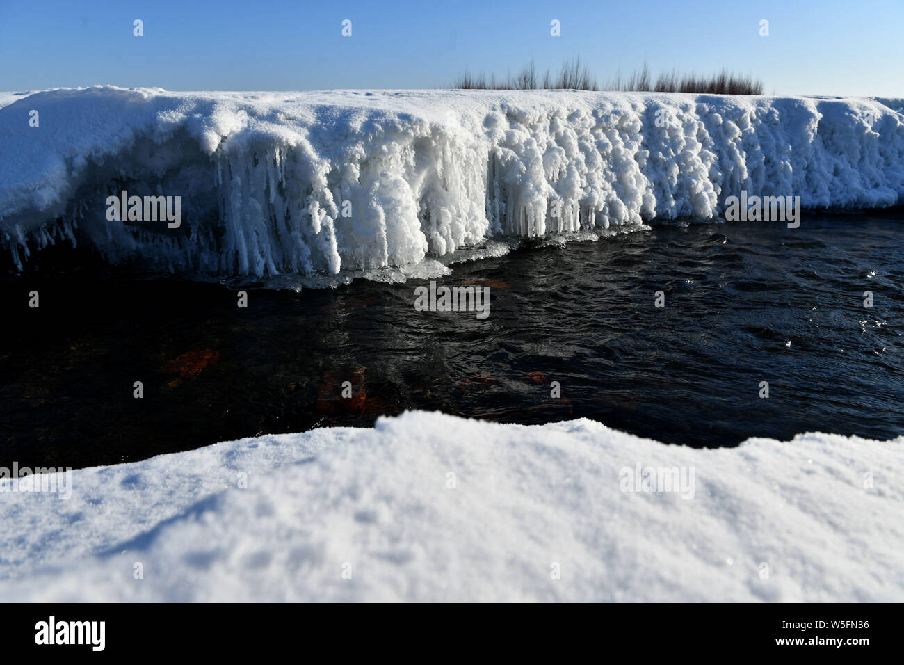 A snowy landscape of the scenic area of Zhadun River covered with snow ...