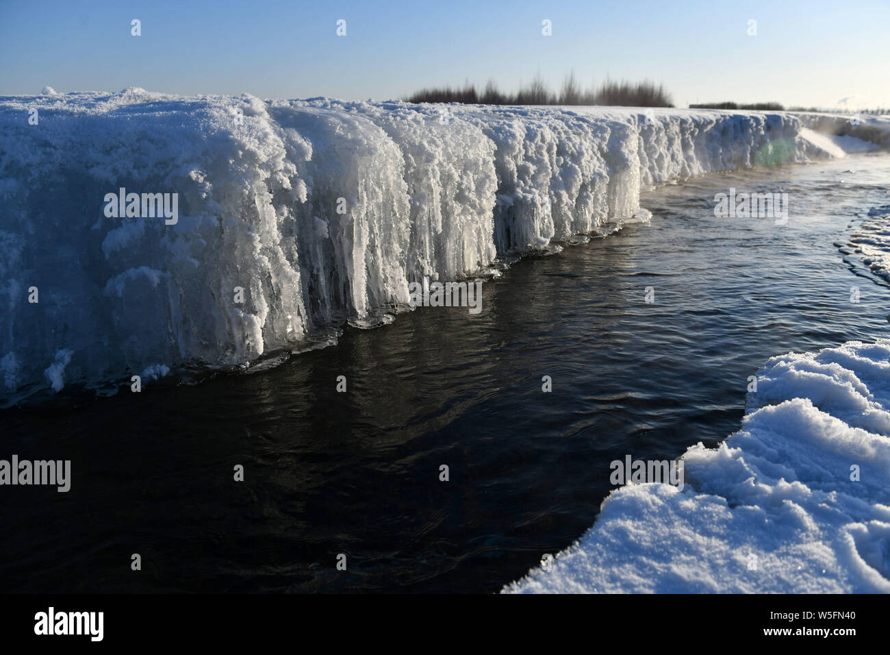 A snowy landscape of the scenic area of Zhadun River covered with snow ...