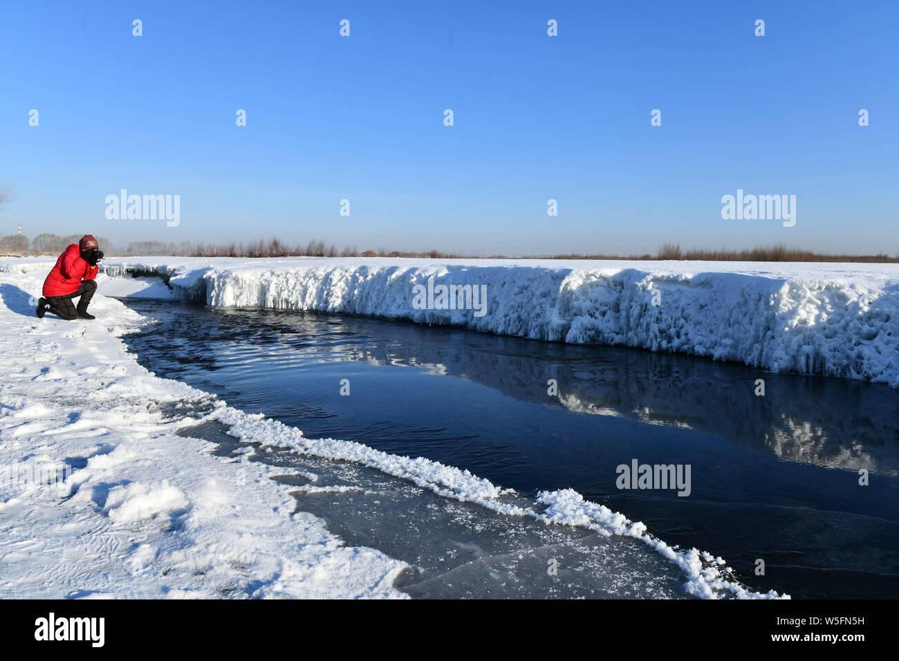 A snowy landscape of the scenic area of Zhadun River covered with snow ...
