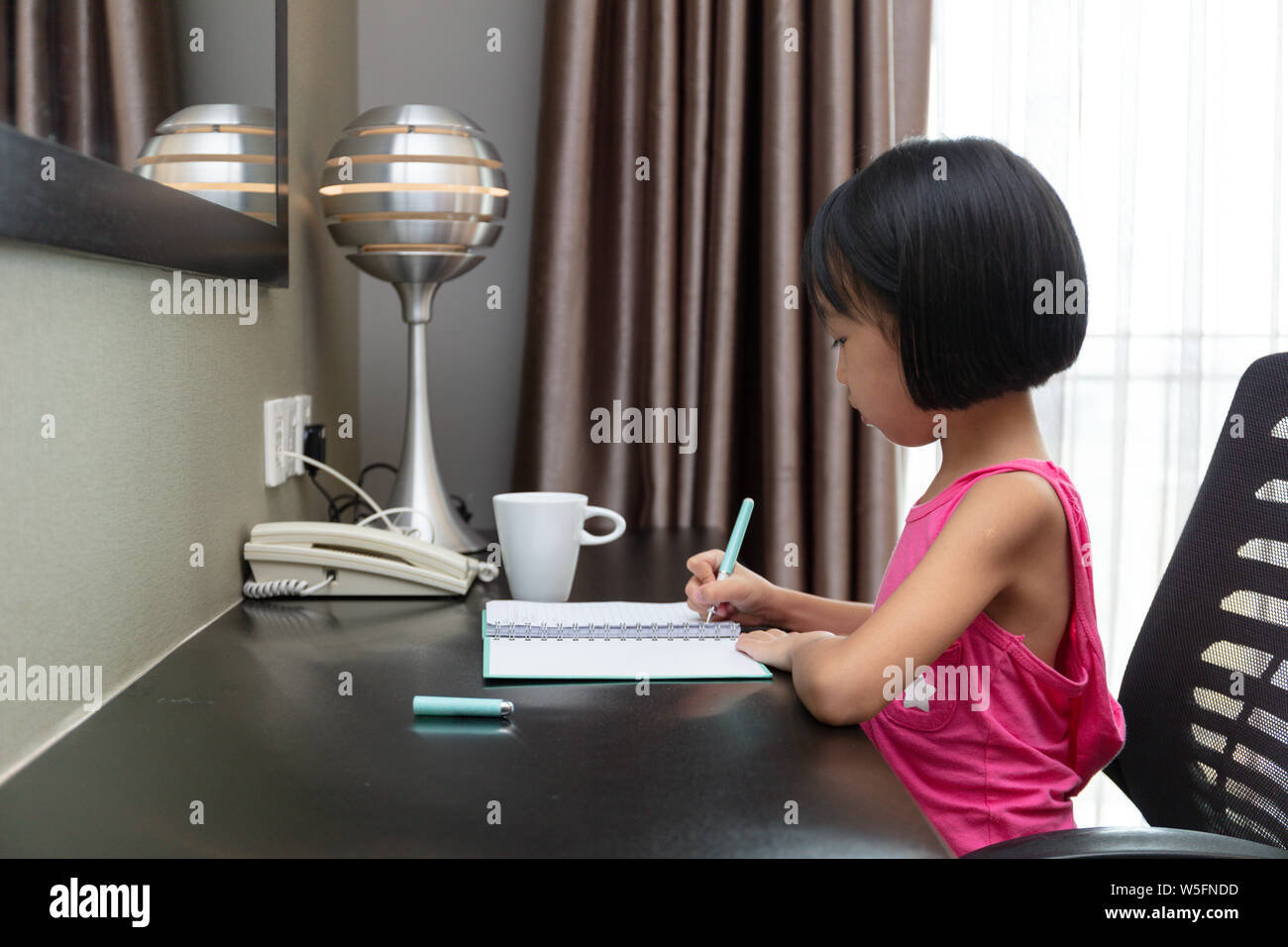 Asian Little Chinese Girl doing homework at home Stock Photo - Alamy