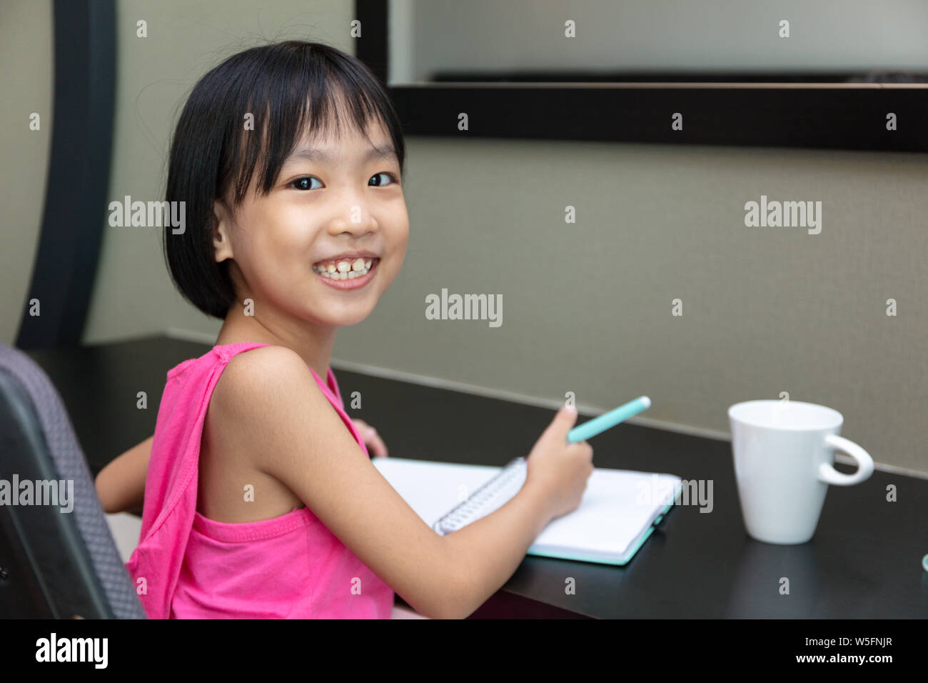 Asian Little Chinese Girl doing homework at home Stock Photo - Alamy