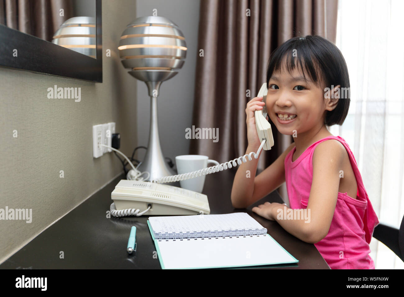 Asian Little Chinese Girl making calls at home Stock Photo - Alamy