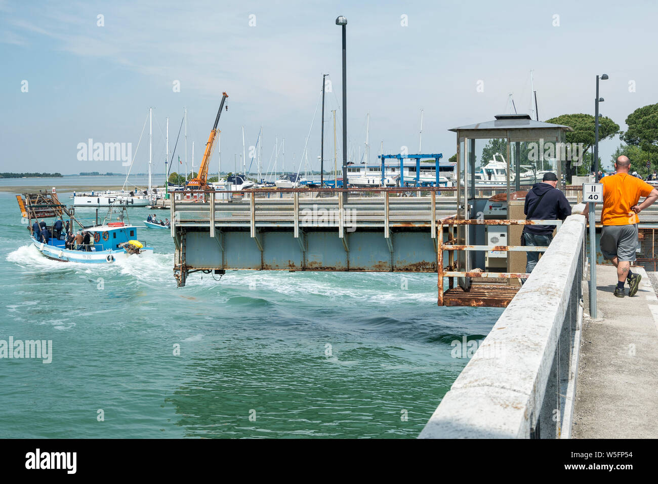Italy, Friuli, Grado, fishing boat going through the swing bridge Stock ...