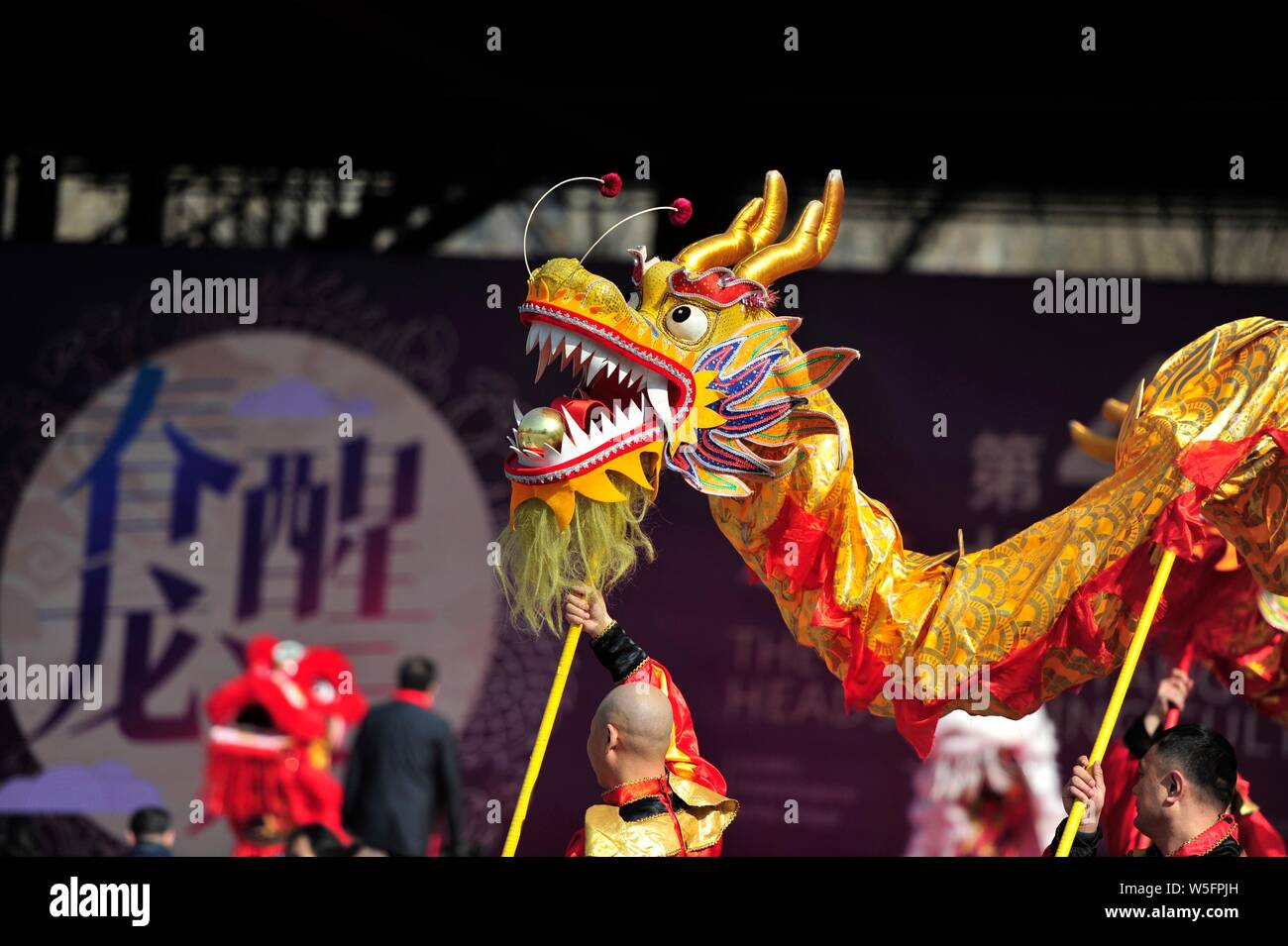 Chinese entertainers perform a dragon dance to celebrate the Dragon ...