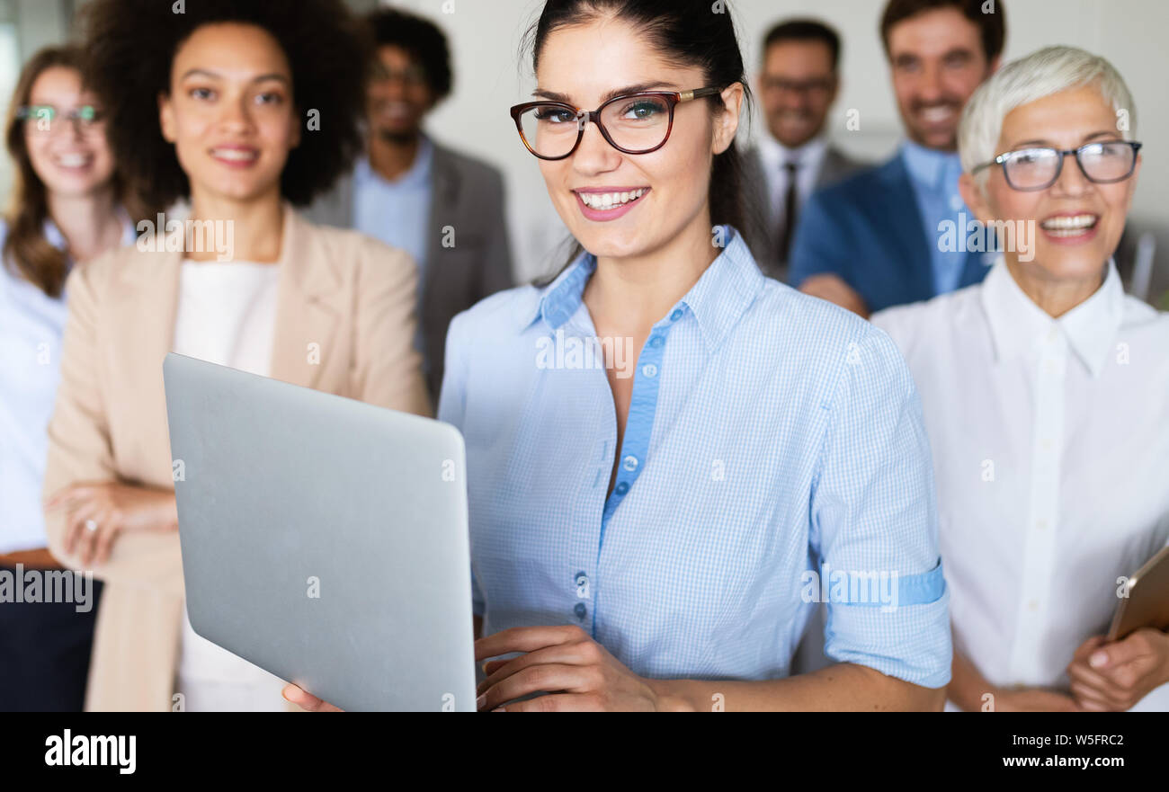 Successful company with happy workers in office Stock Photo - Alamy