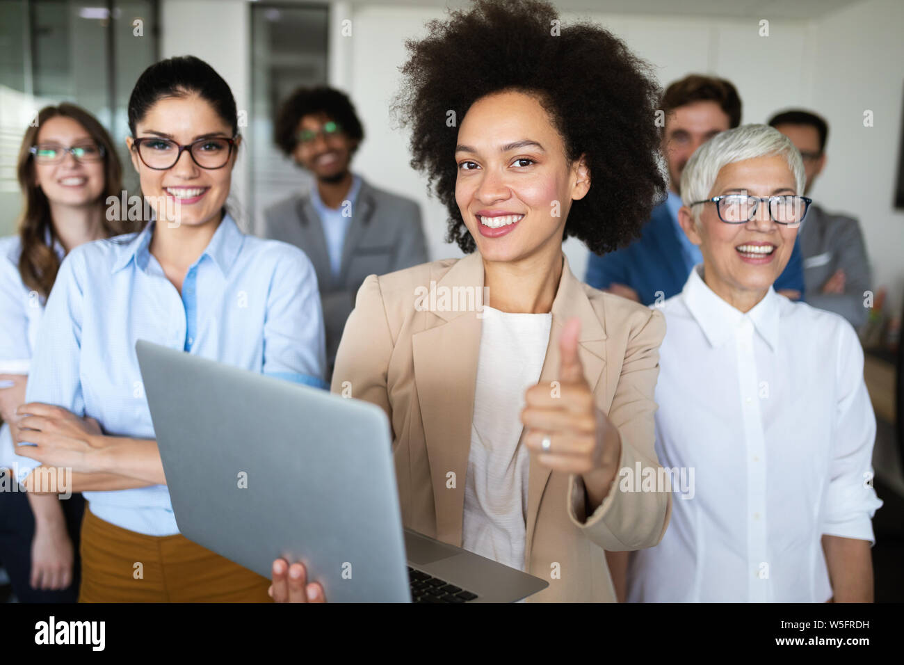 Happy business people celebrating success at company Stock Photo - Alamy