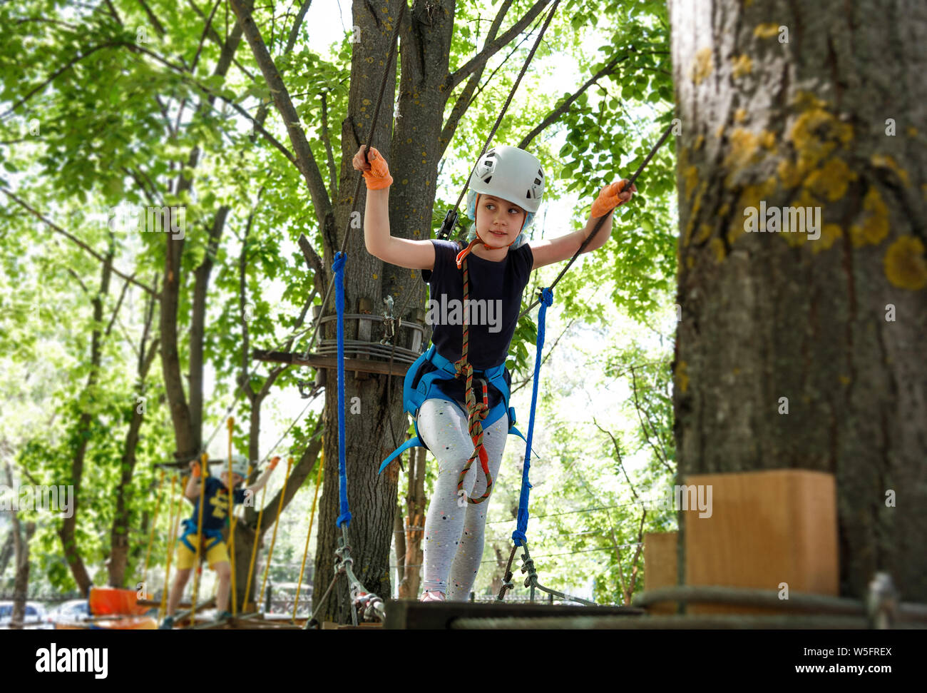 Kid climbing in monkey bar hi-res stock photography and images - Alamy