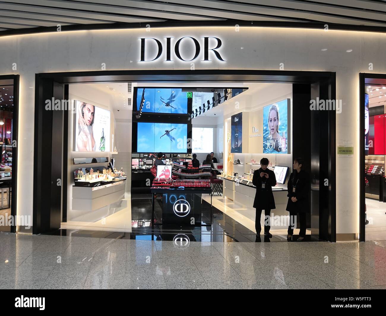 --FILE--Chinese employees are seen in front of a boutique store of Dior ...