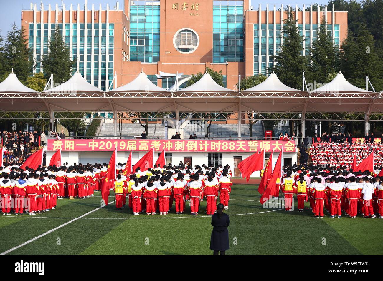 Chinese students queue up in lines during a mass rally for the upcoming ...