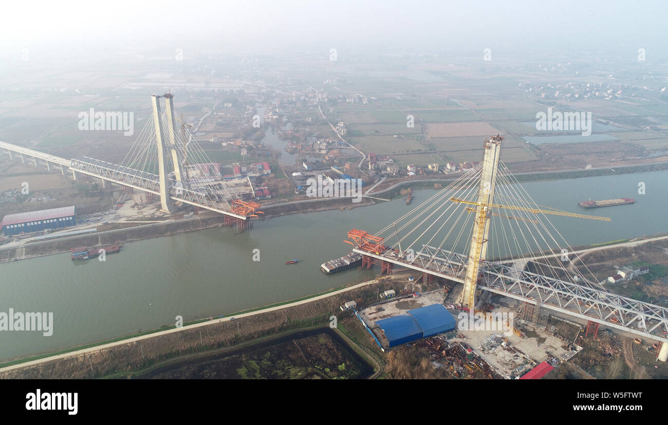 Chinese workers labor at the construction of the Yuxi River bridge on ...