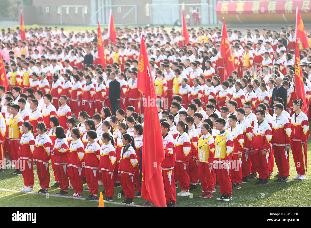 Chinese students queue up in lines during a mass rally for the upcoming ...