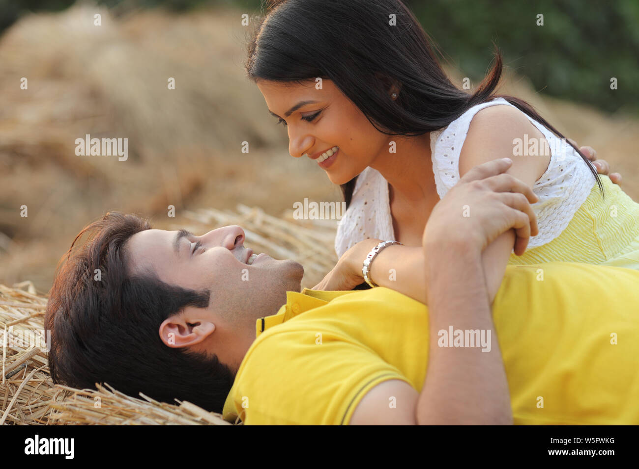 Couple romancing and smiling Stock Photo - Alamy