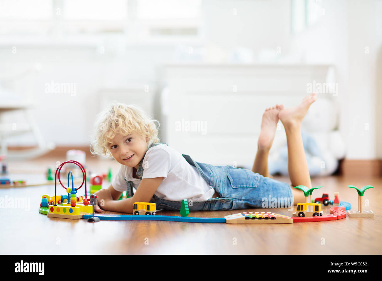 Kids play with wooden railway. Child with toy train. Educational toys ...