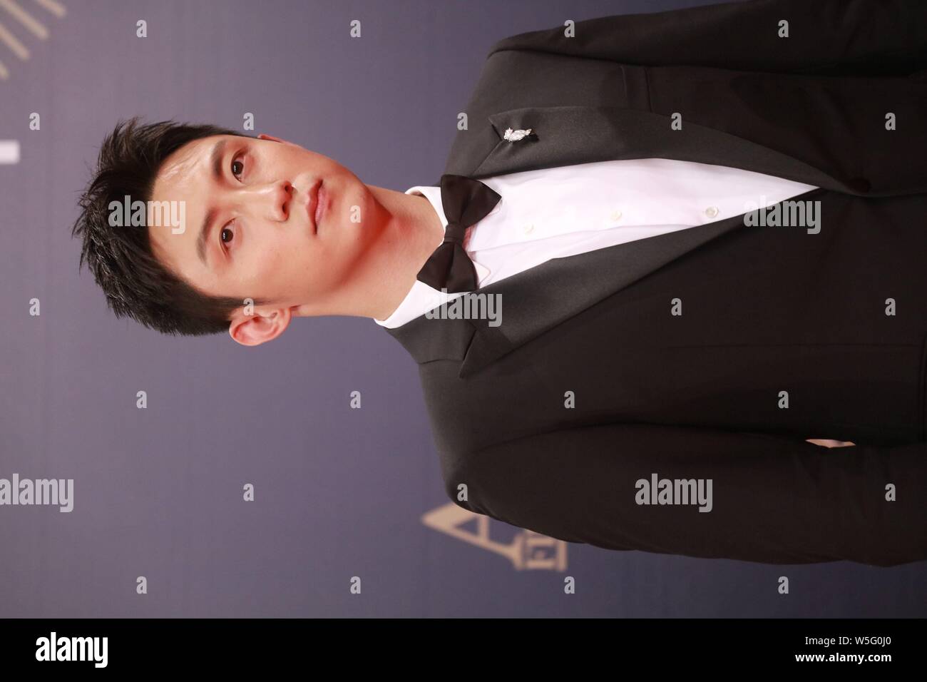 Chinese actor Johnny Huang Jingyu poses with his trophy after winning ...