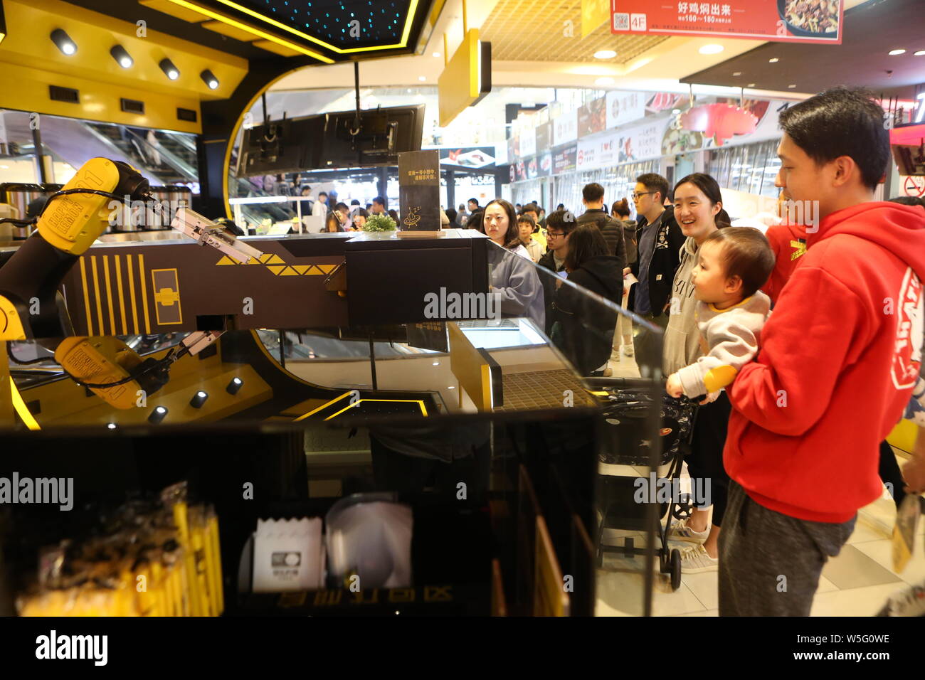 A robot arm makes milk tea at an automated store in Shanghai, China, 17 ...