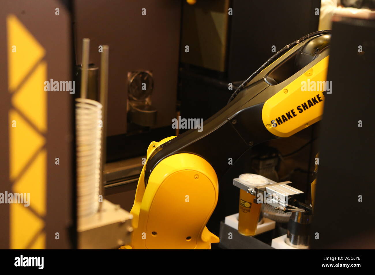 A robot arm makes milk tea at an automated store in Shanghai, China, 17 ...