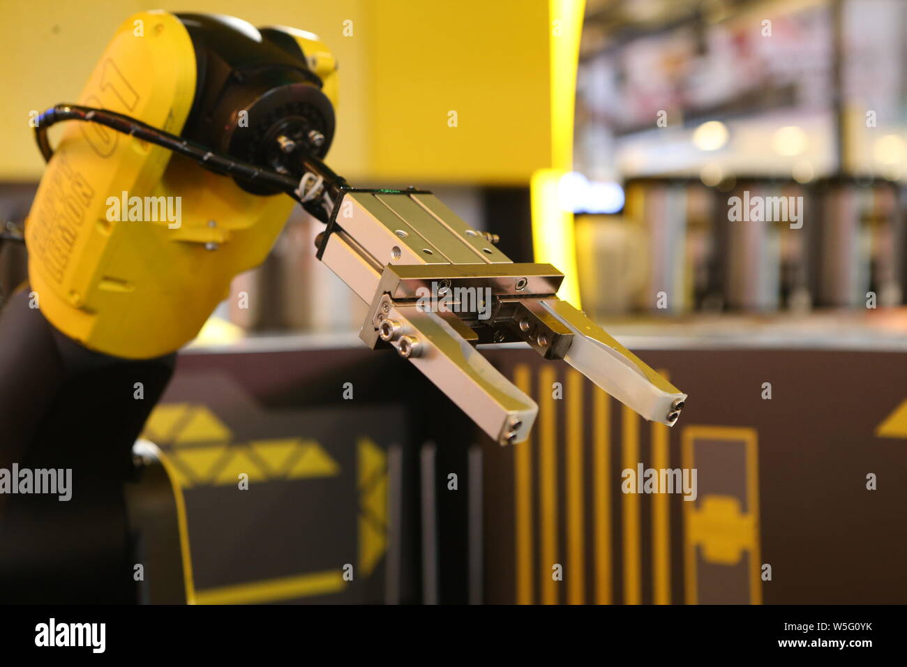 A robot arm makes milk tea at an automated store in Shanghai, China, 17 ...