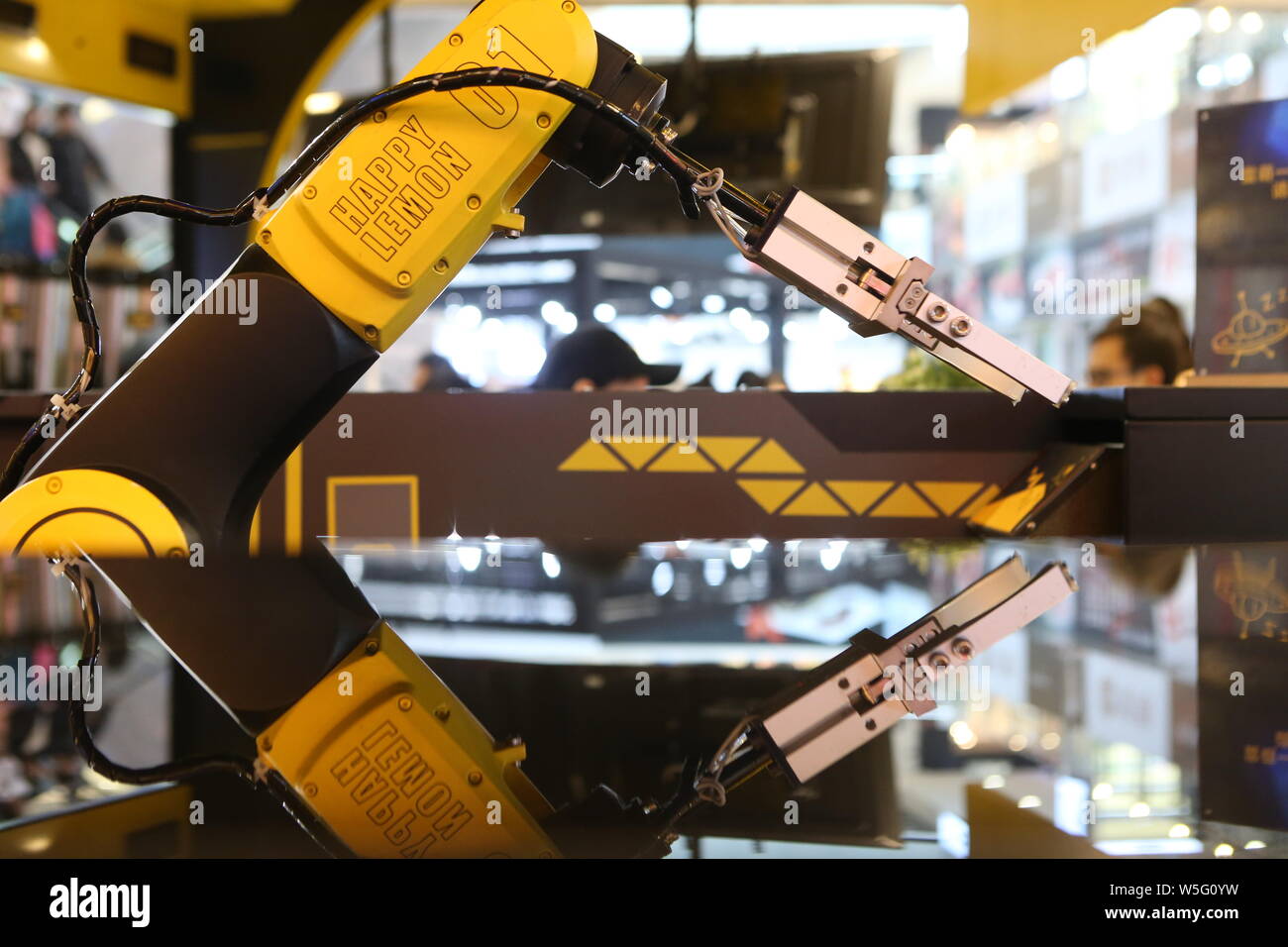 A robot arm makes milk tea at an automated store in Shanghai, China, 17 ...