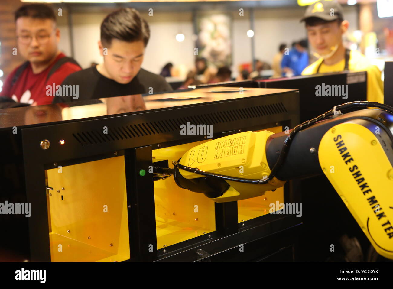 A robot arm makes milk tea at an automated store in Shanghai, China, 17 ...