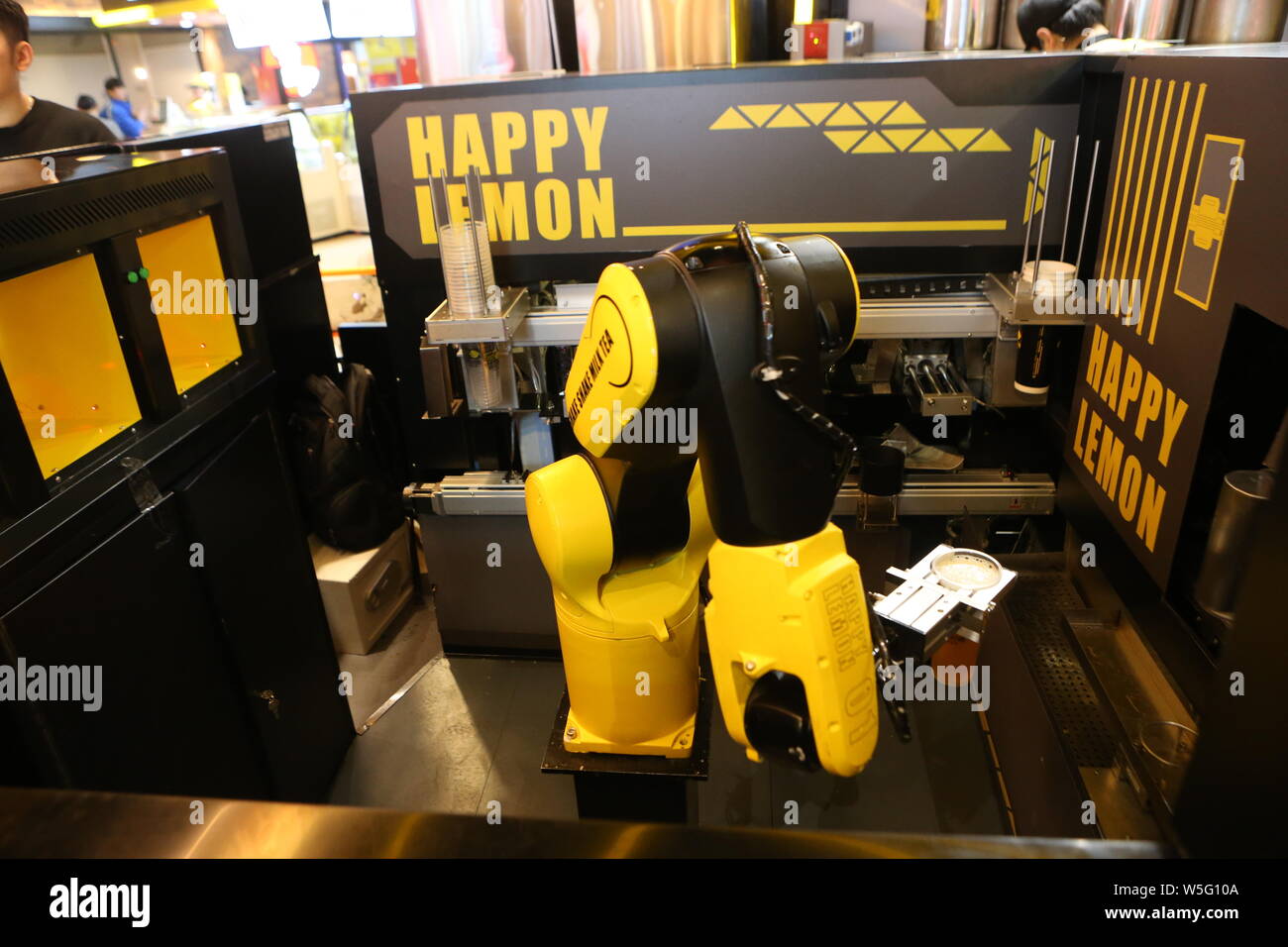 A robot arm makes milk tea at an automated store in Shanghai, China, 17 ...