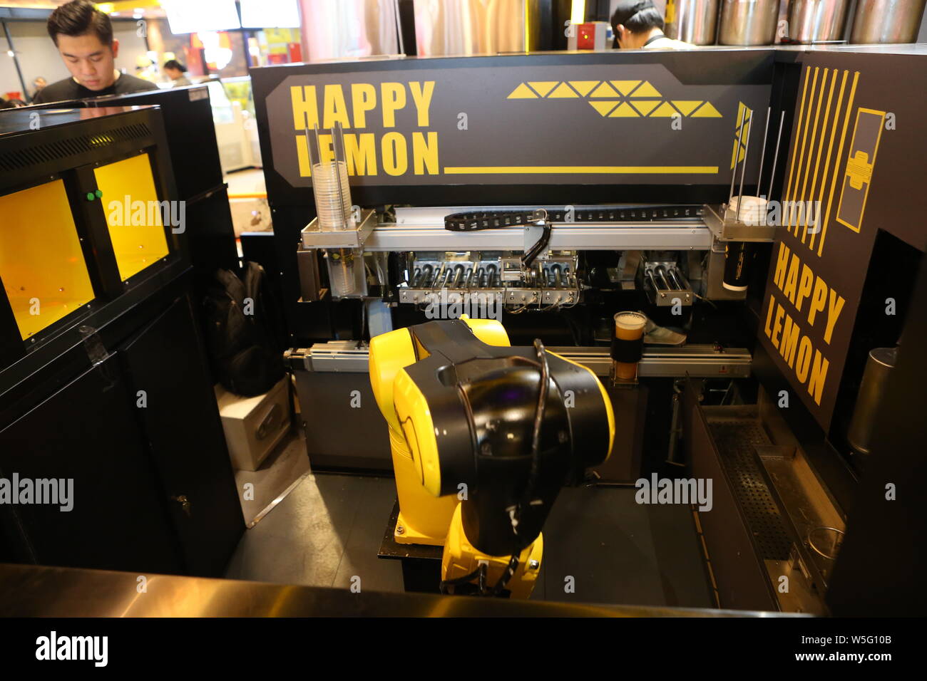 A robot arm makes milk tea at an automated store in Shanghai, China, 17 ...